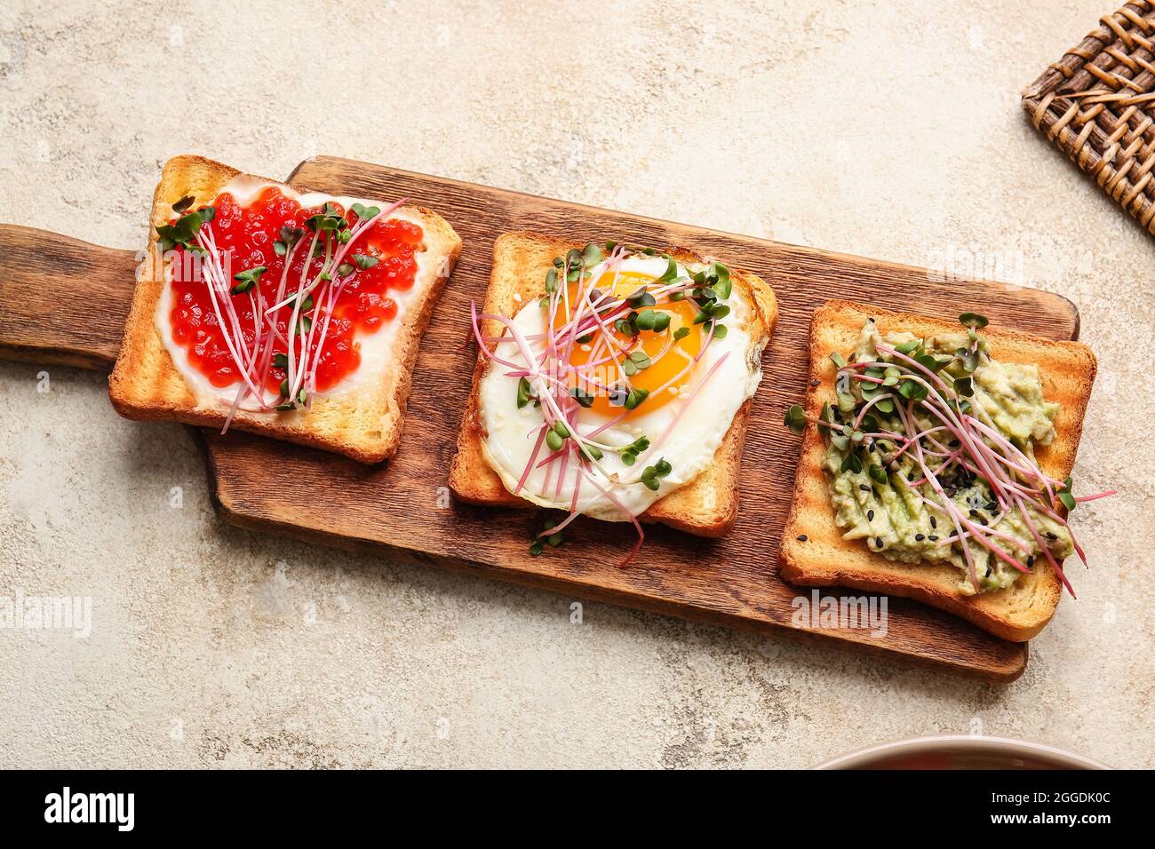 Wooden board with different toasts on grunge background Stock Photo - Alamy