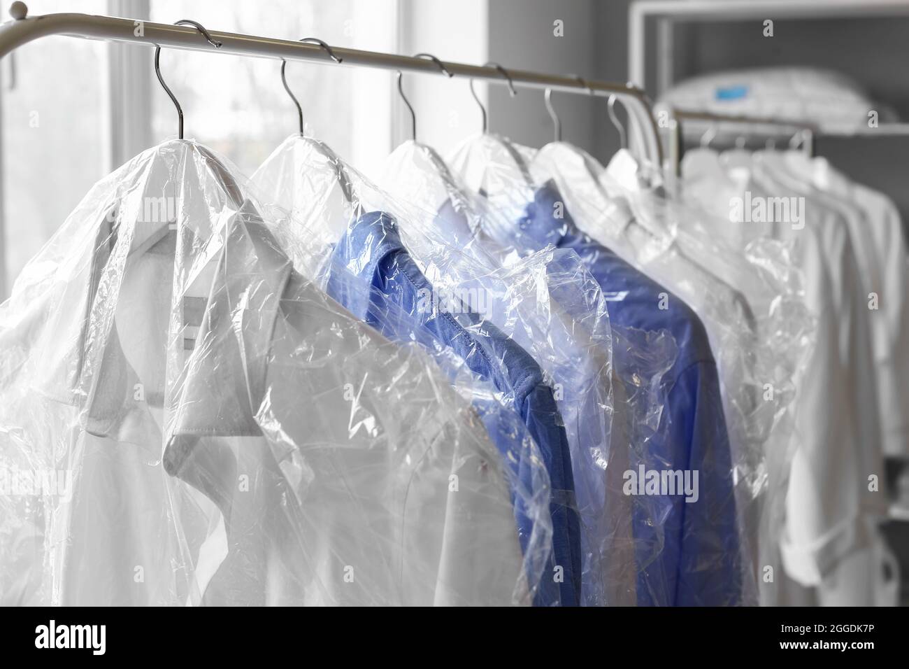 Rack with clothes at modern dry-cleaner's Stock Photo - Alamy