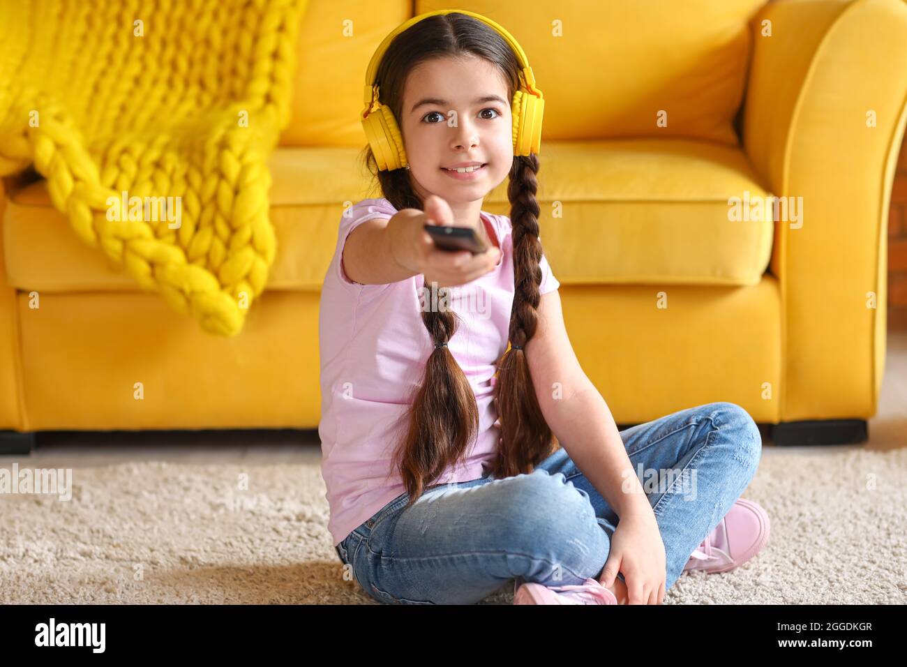 Cute girl watching cartoons at home Stock Photo - Alamy