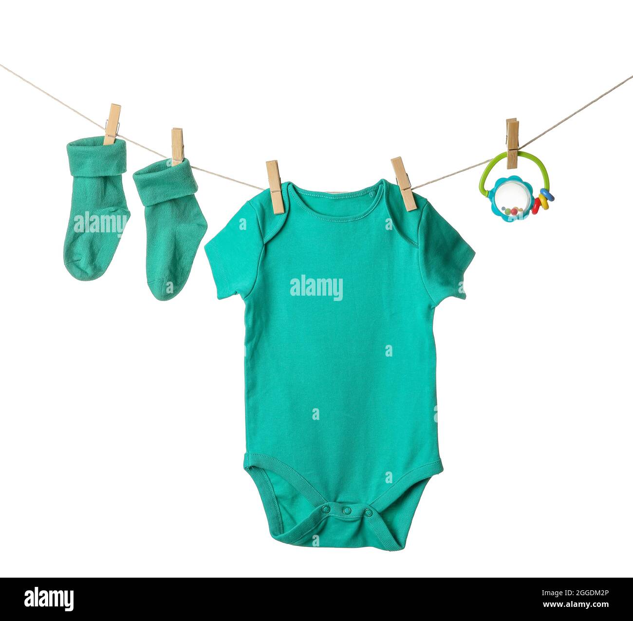 Baby clothes and toy hanging on rope against white background Stock ...