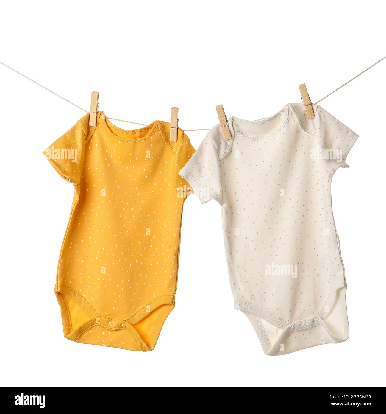 Baby clothes hanging on rope against white background Stock Photo - Alamy