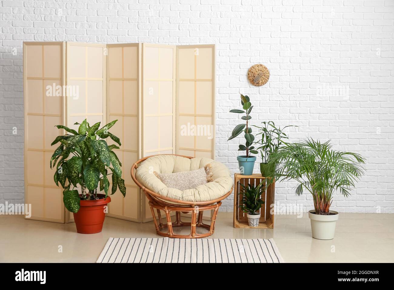 Interior of stylish living room with folding screen Stock Photo - Alamy