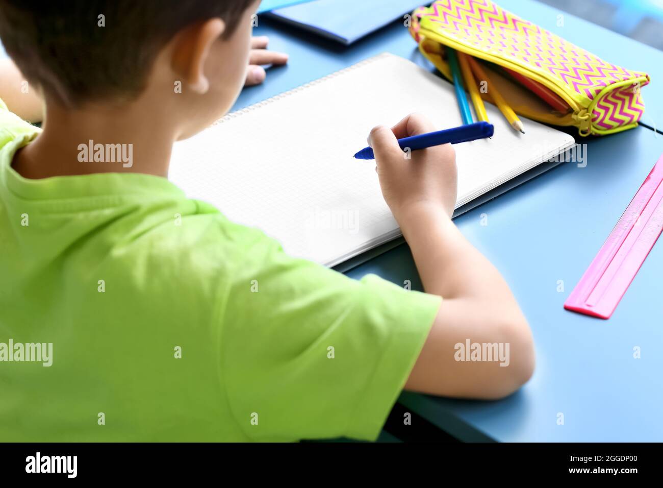 Little boy doing lessons at home Stock Photo - Alamy