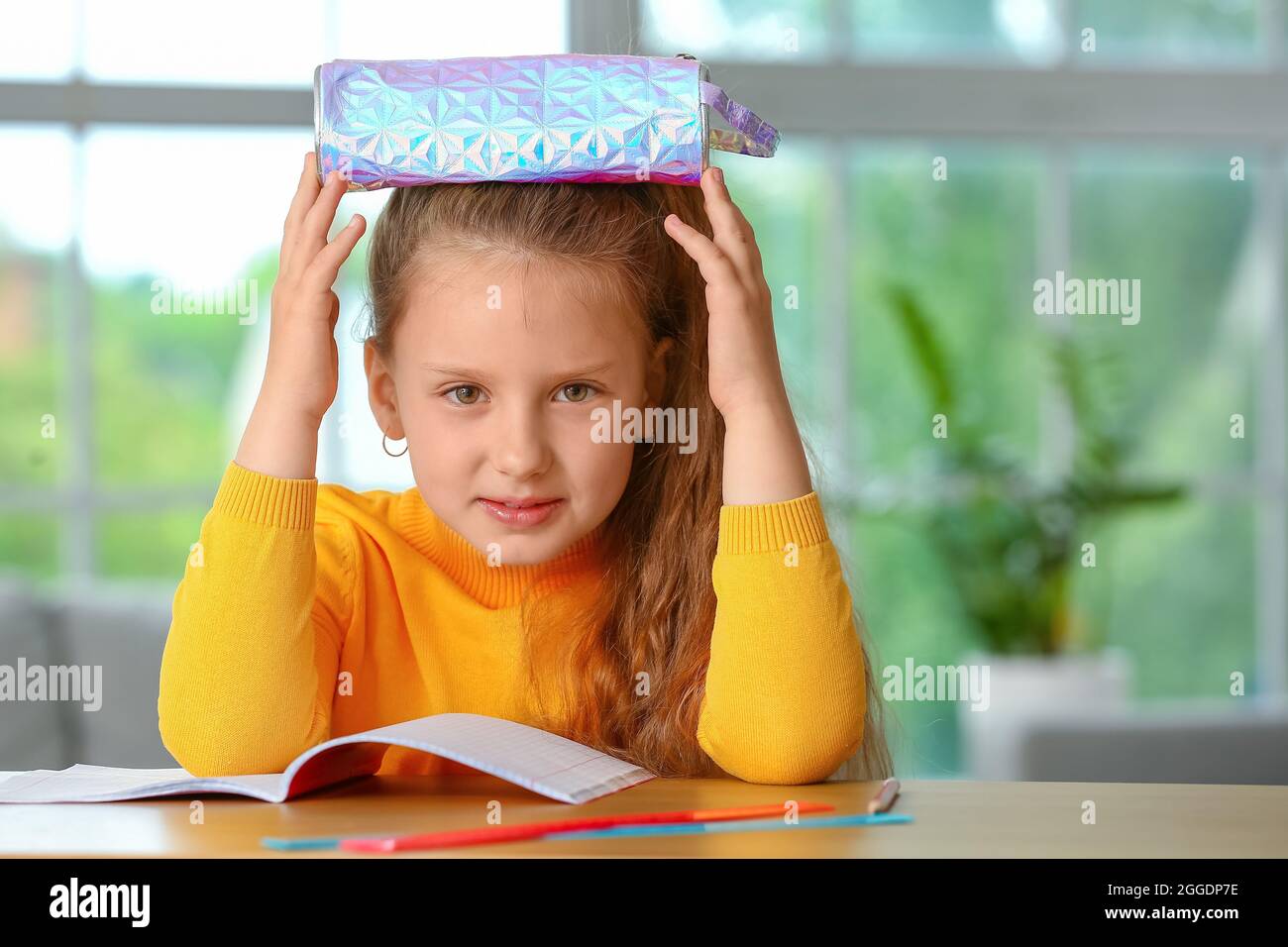 Little girl with pencil case at home Stock Photo - Alamy