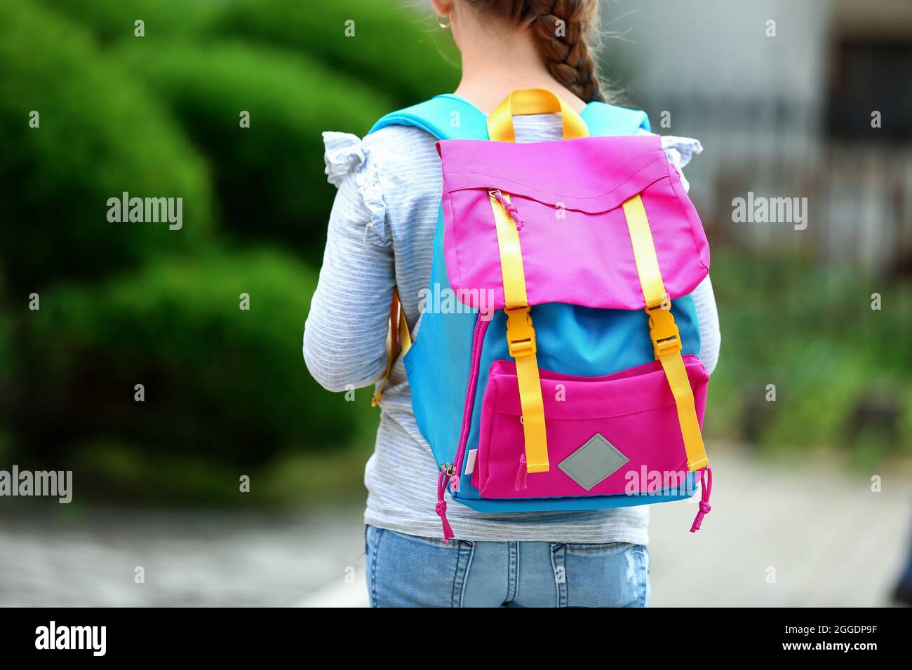 Little schoolgirl with backpack outdoors Stock Photo - Alamy