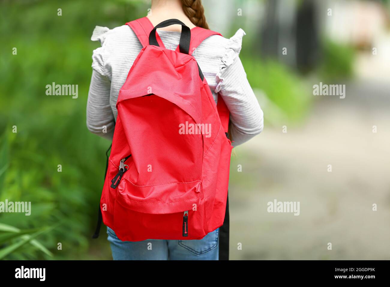 Little schoolgirl with backpack outdoors Stock Photo - Alamy