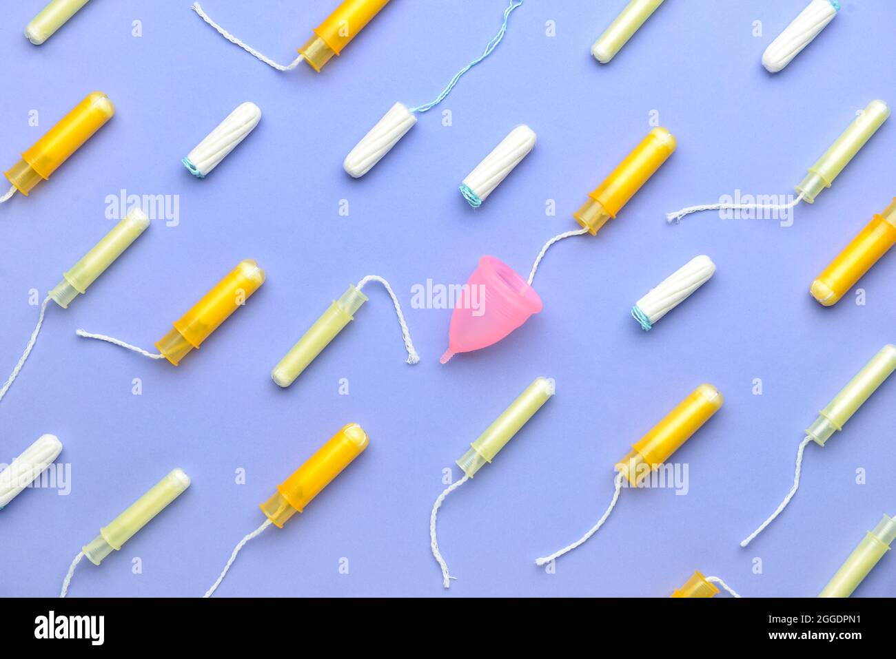 Tampons and menstrual cup on color background Stock Photo - Alamy