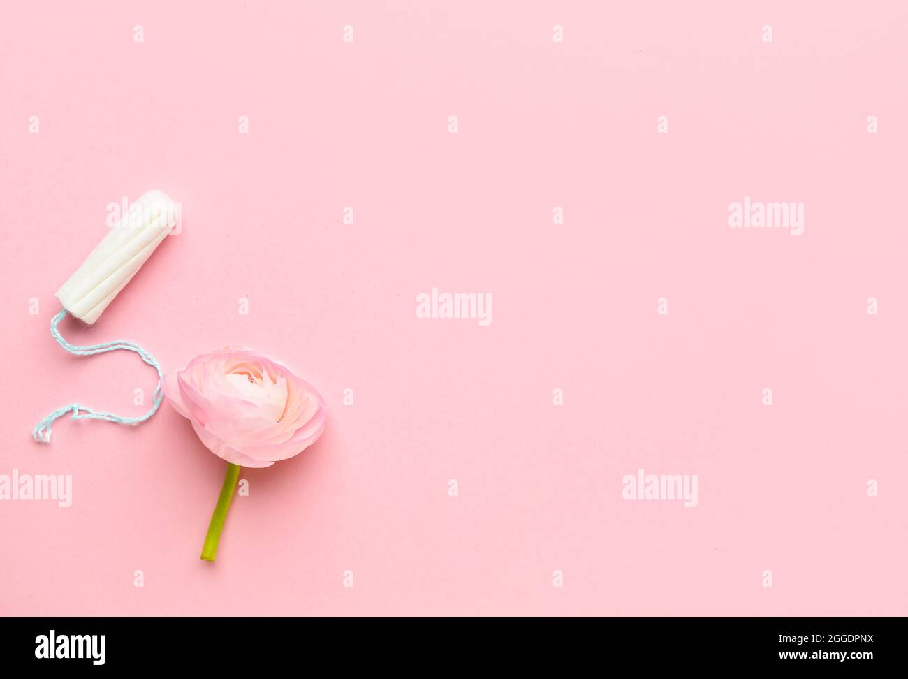 Tampon and flower on color background Stock Photo - Alamy