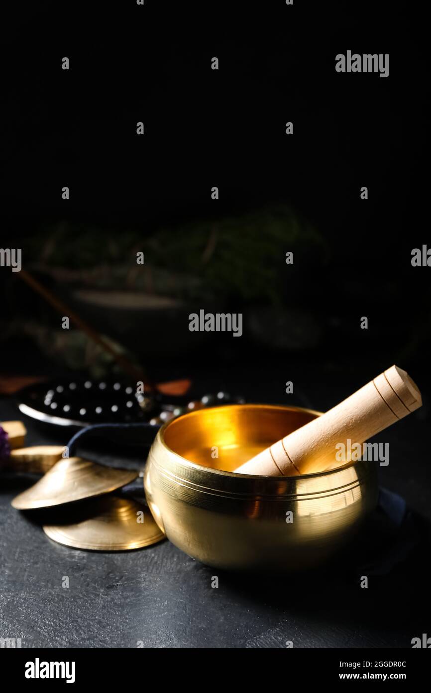 Tibetan singing bowl with karatalas on dark background Stock Photo - Alamy