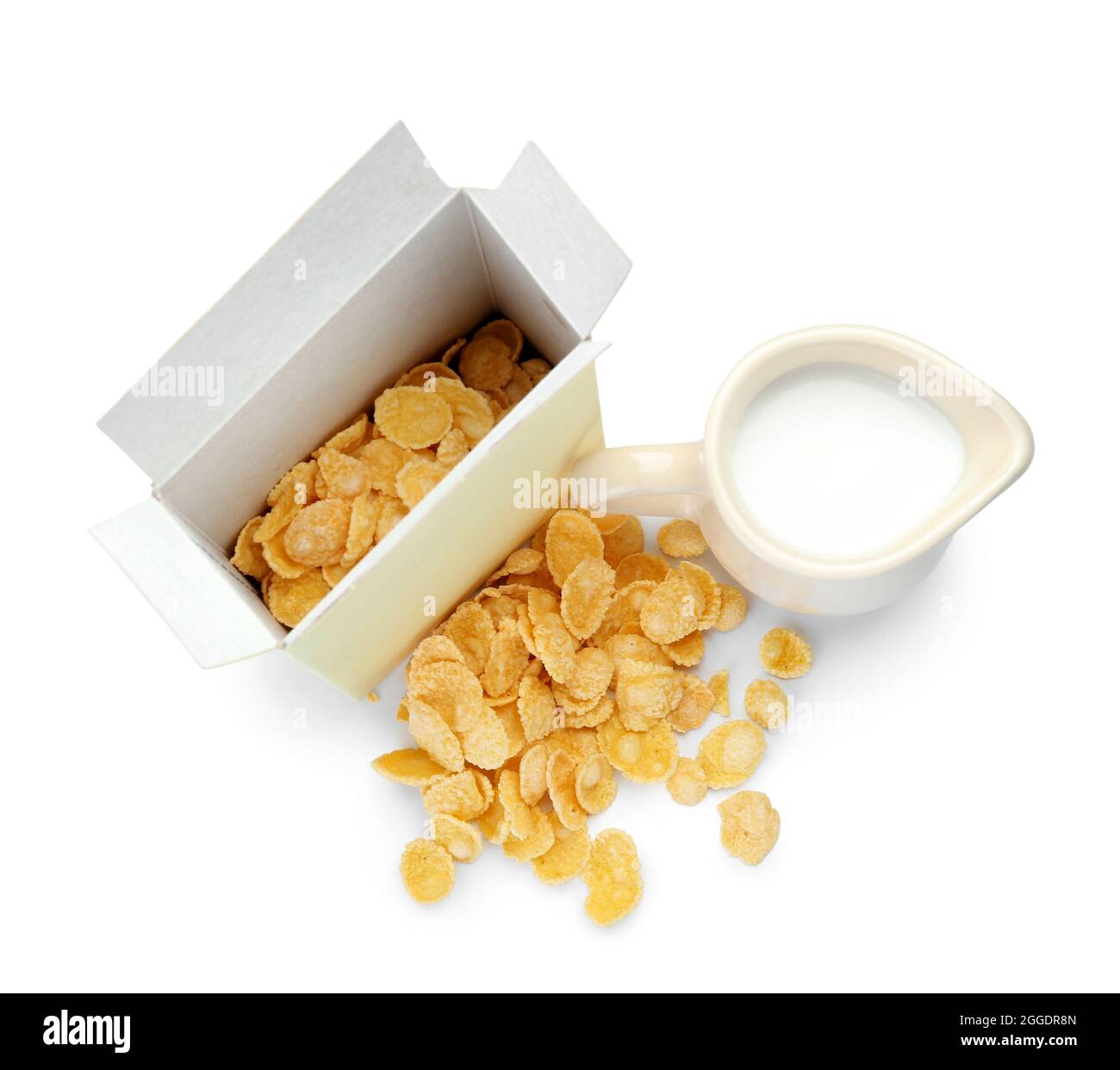 Box with tasty cornflakes and jug of milk on white background Stock ...