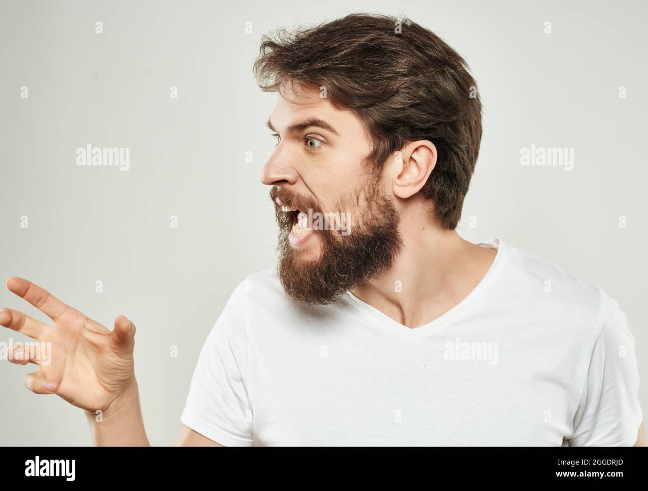 Man in a white t-shirt hand gestures anger close-up Stock Photo - Alamy