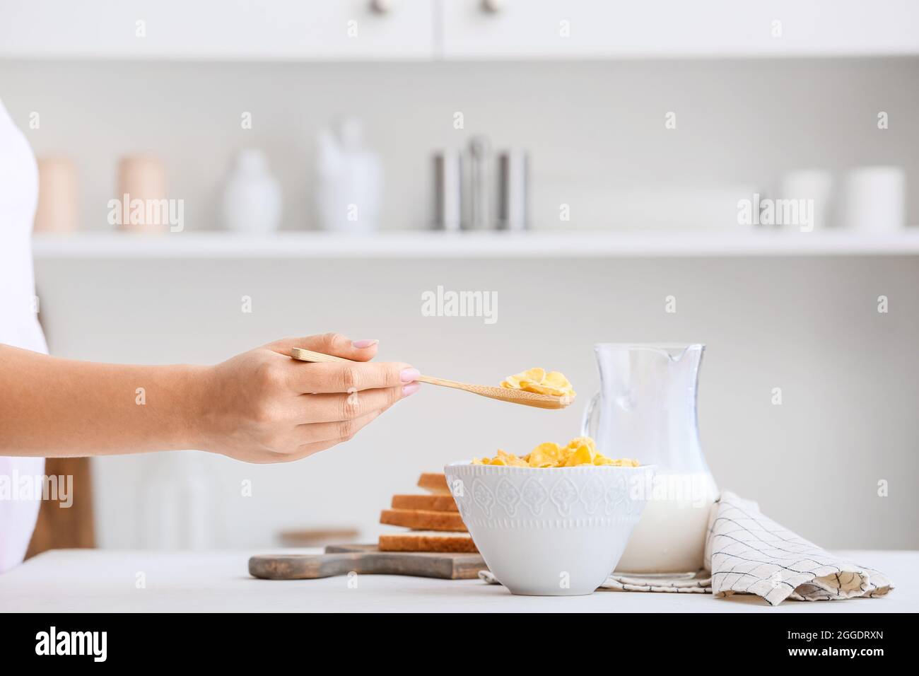 Woman eating corn flakes hi-res stock photography and images - Alamy