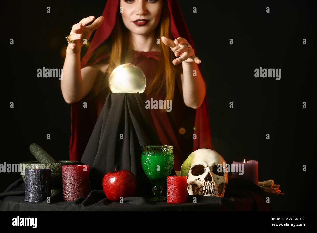 Witch performing ritual on dark background Stock Photo - Alamy