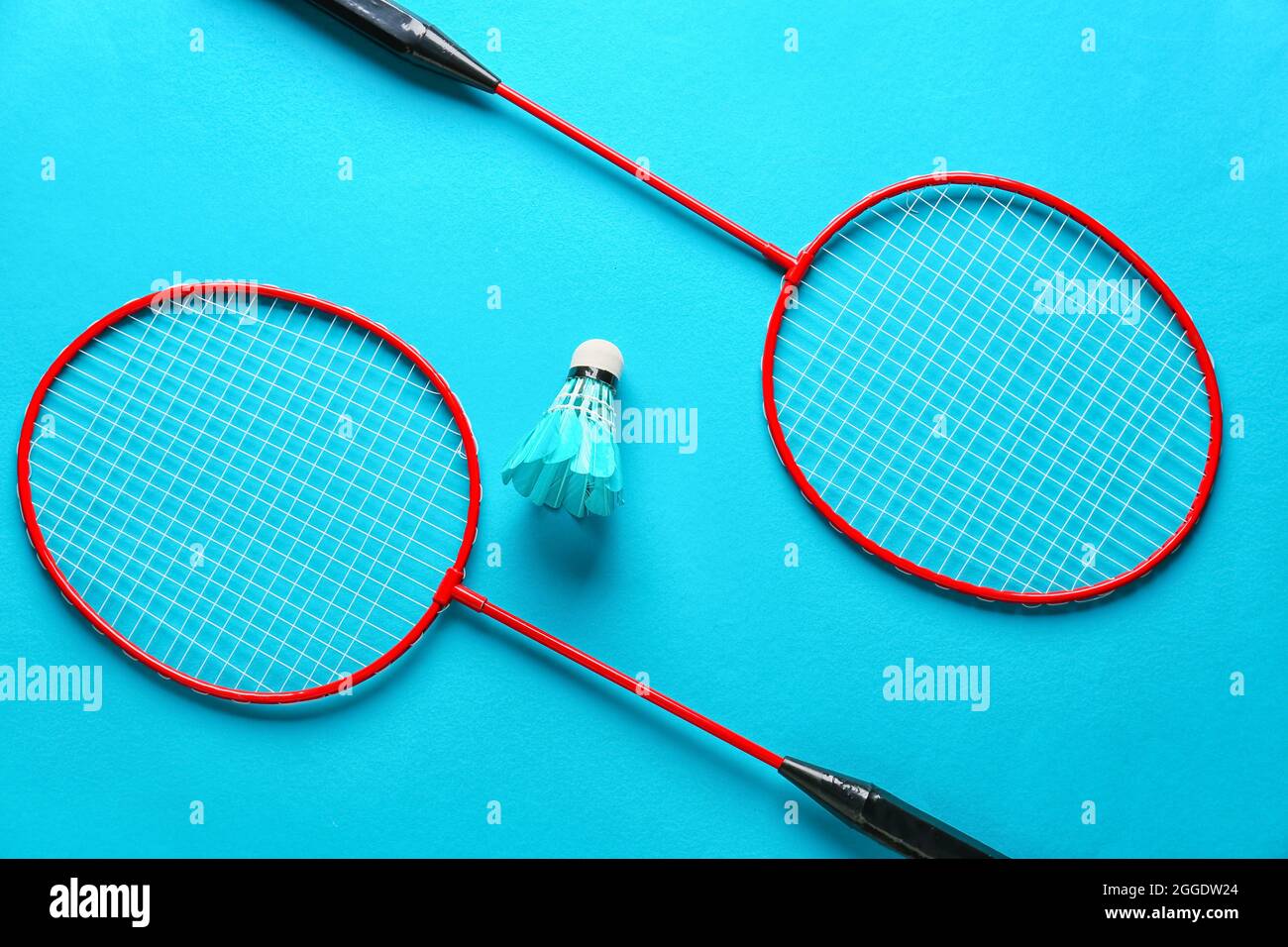 Badminton rackets and shuttlecock on color background Stock Photo - Alamy