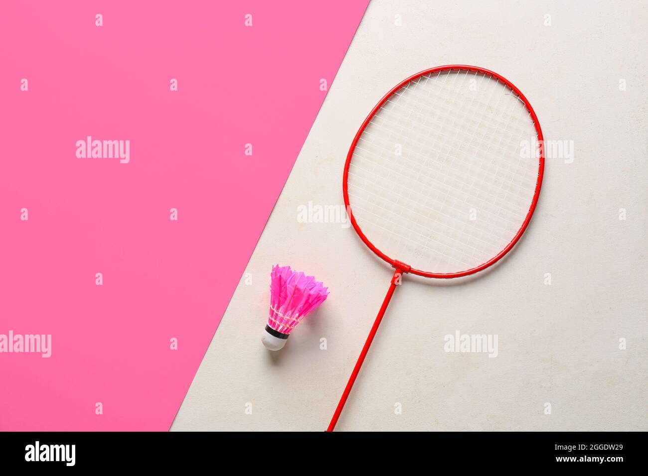 Badminton racket and shuttlecock on color background Stock Photo - Alamy