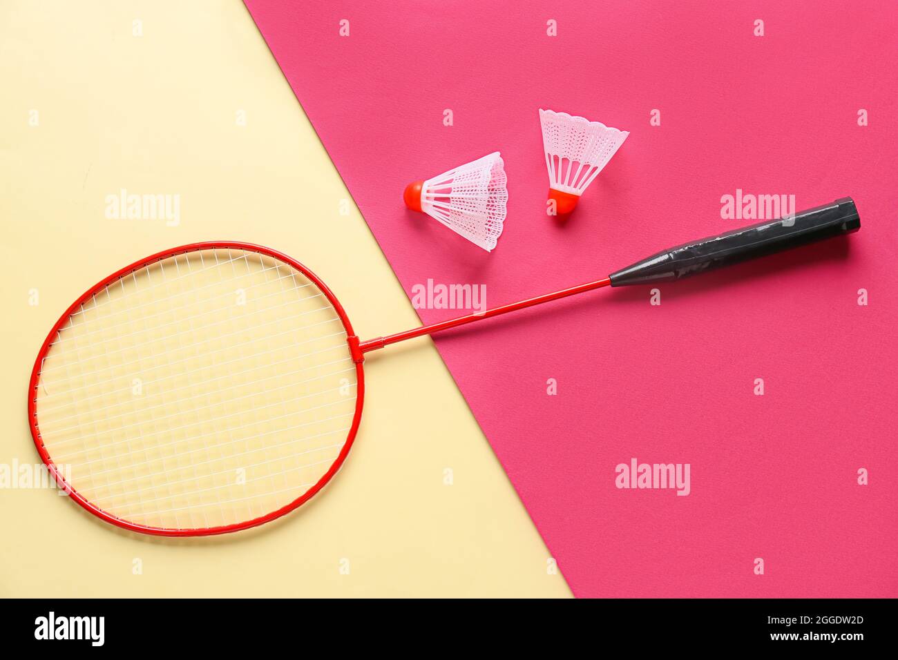 Badminton racket and shuttlecocks on color background Stock Photo - Alamy