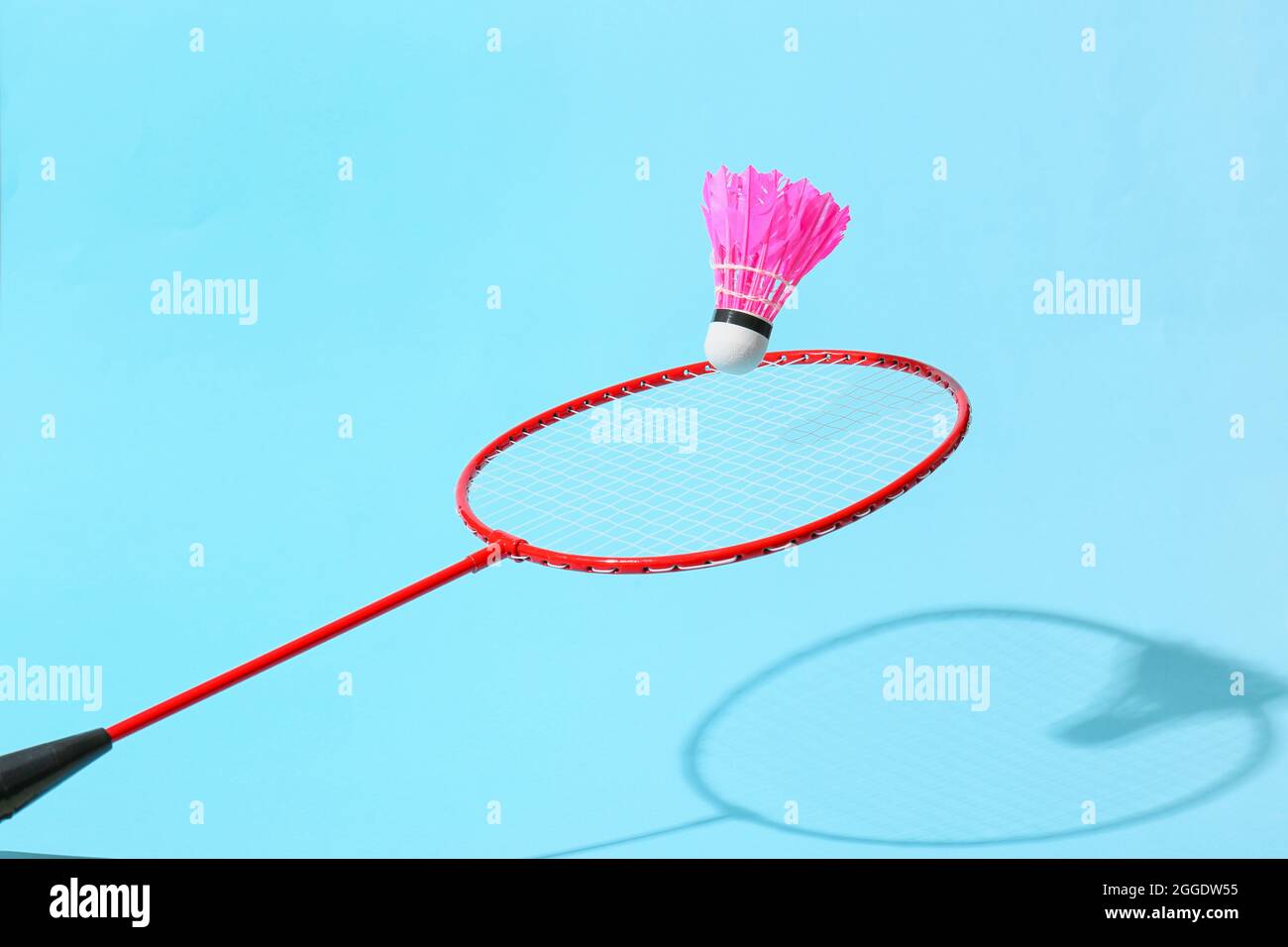 Badminton racket and shuttlecock on color background Stock Photo - Alamy