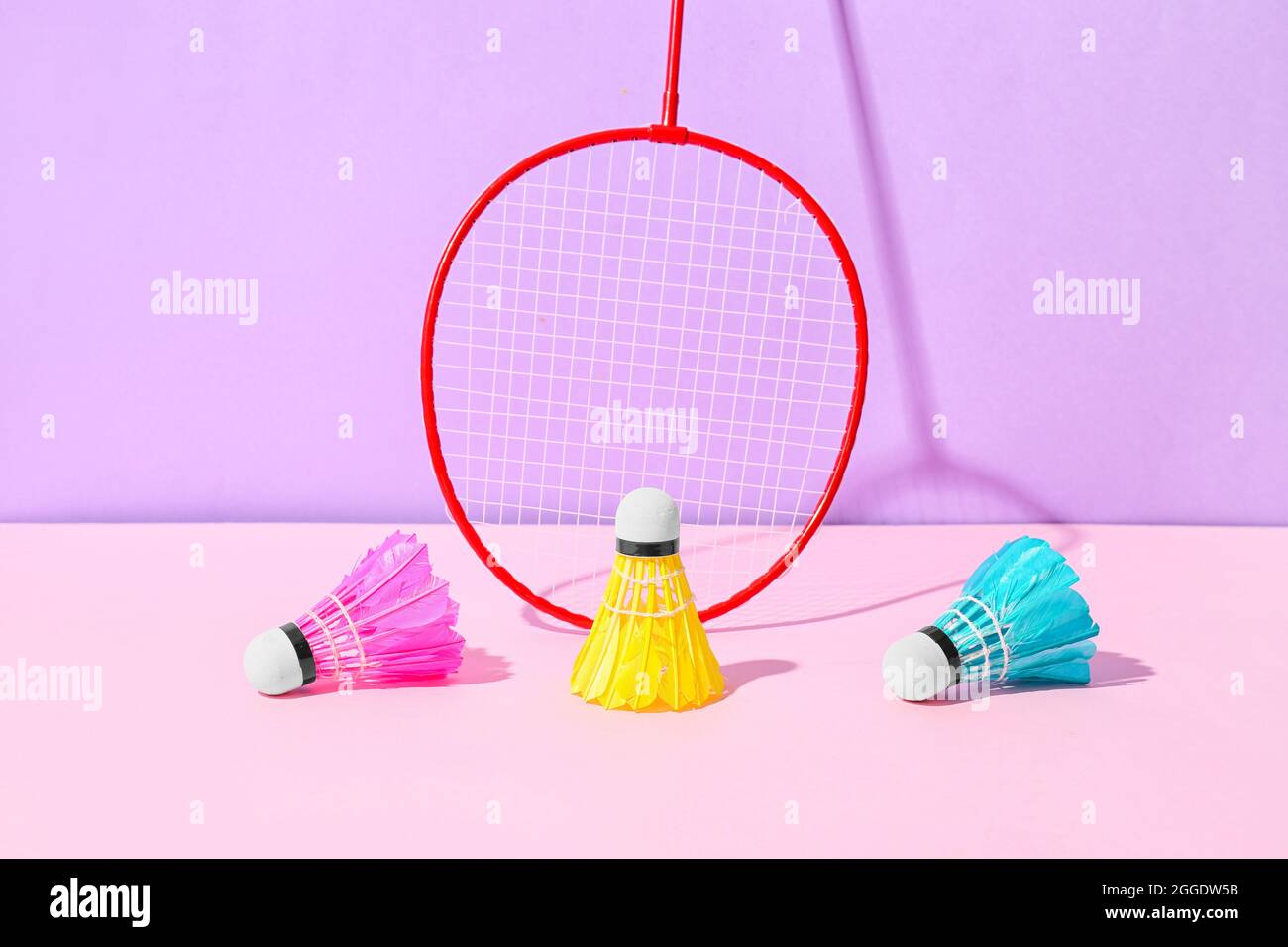 Badminton racket and shuttlecocks on color background Stock Photo - Alamy