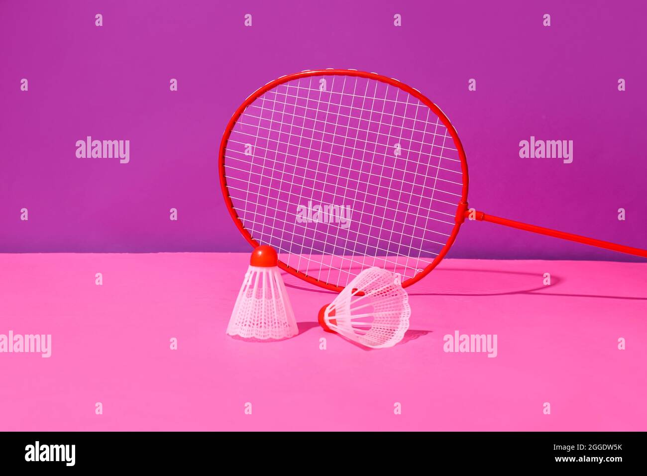 Badminton racket and shuttlecocks on color background Stock Photo - Alamy