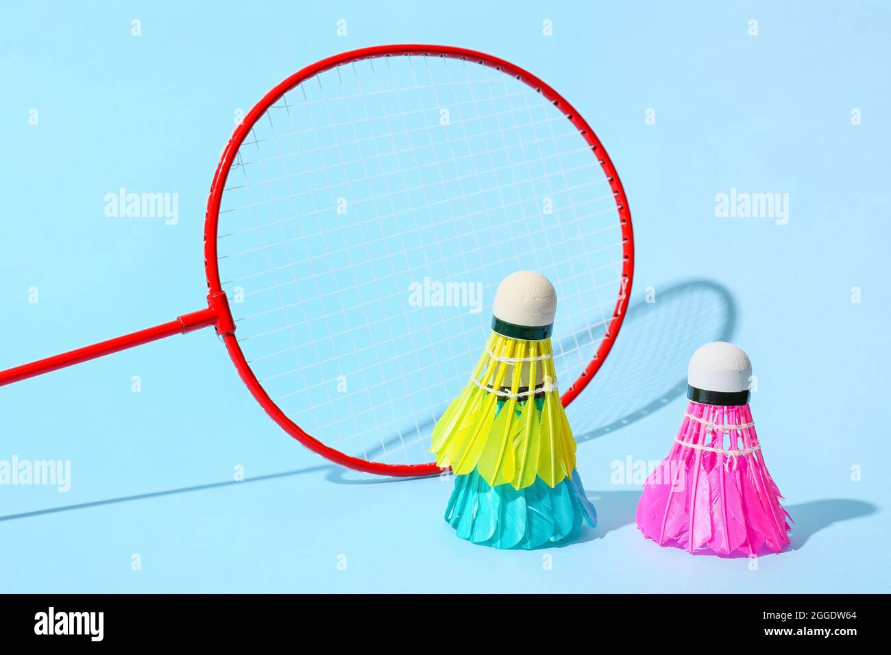 Badminton racket and shuttlecocks on color background Stock Photo - Alamy