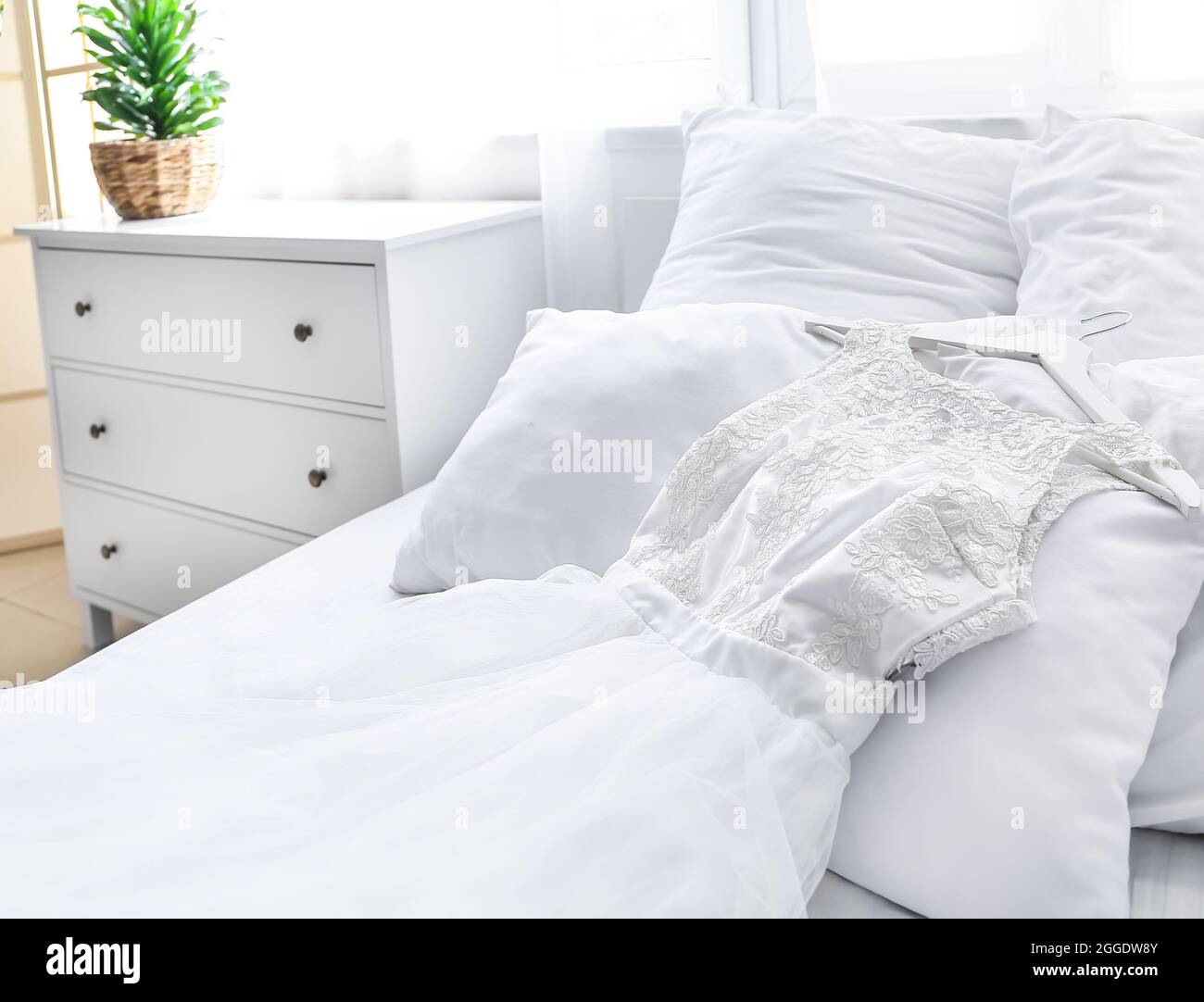 Beautiful wedding dress on bed Stock Photo - Alamy