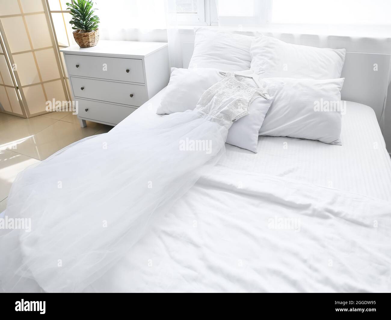 Beautiful wedding dress on bed Stock Photo - Alamy
