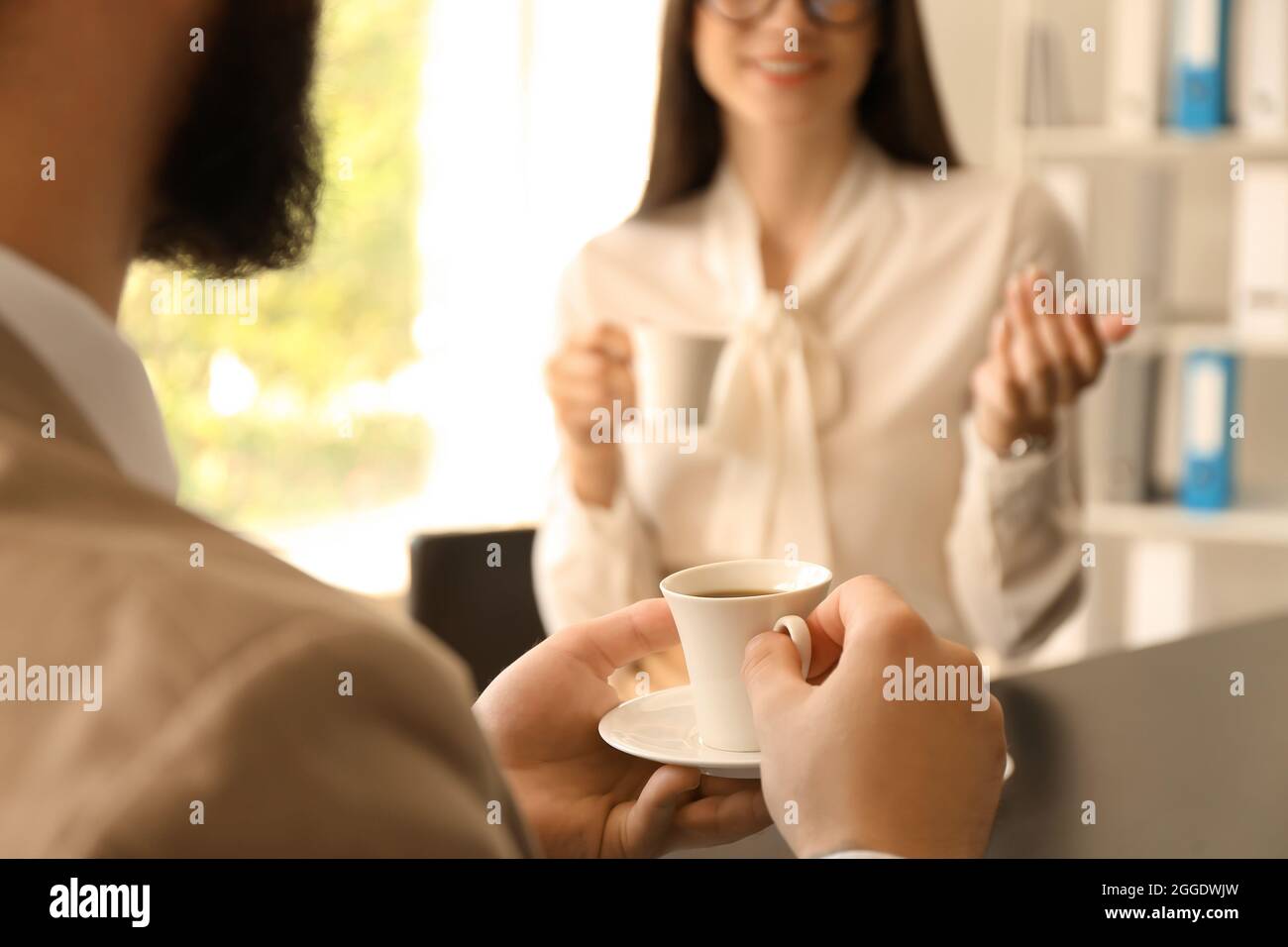 Business people having coffee break in office Stock Photo - Alamy