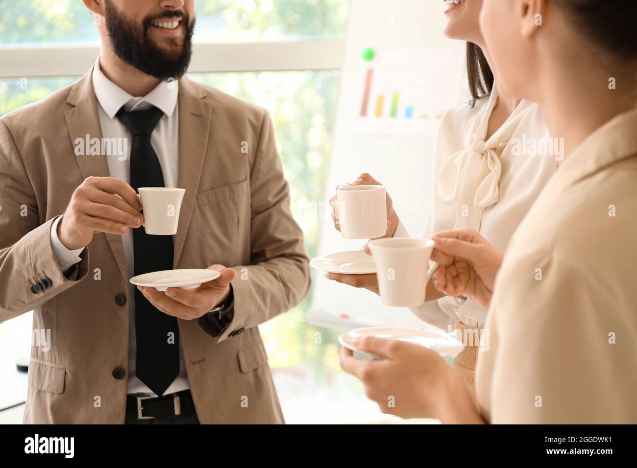 Business people having coffee break in office Stock Photo - Alamy