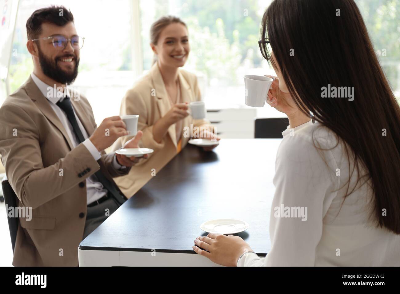 Business people having coffee break in office Stock Photo - Alamy