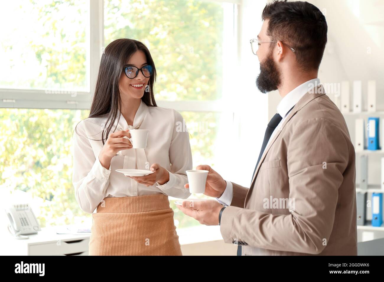 Business people having coffee break in office Stock Photo - Alamy