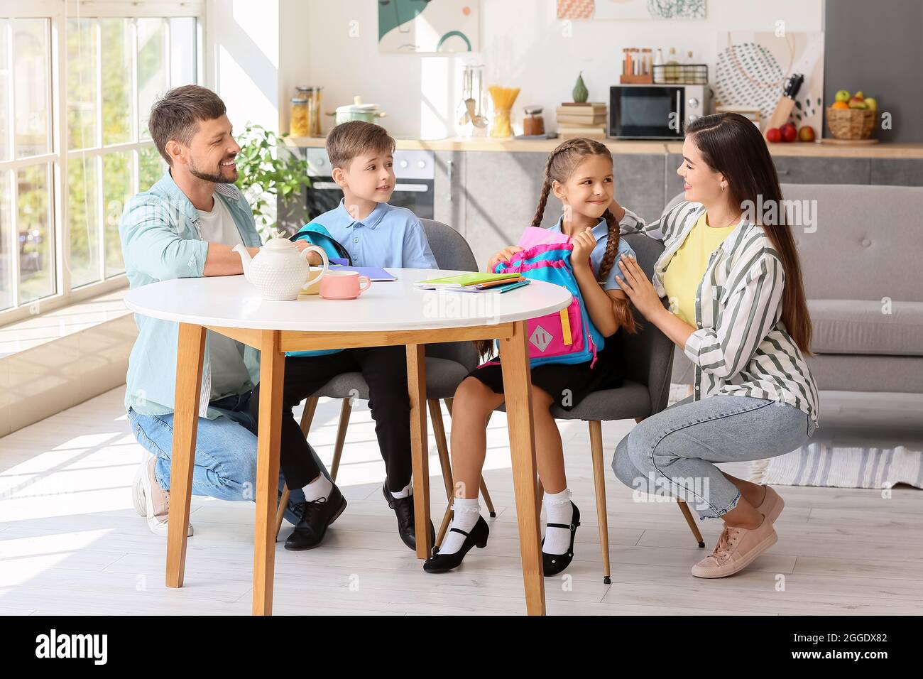 Parents getting their little children ready for school Stock Photo - Alamy