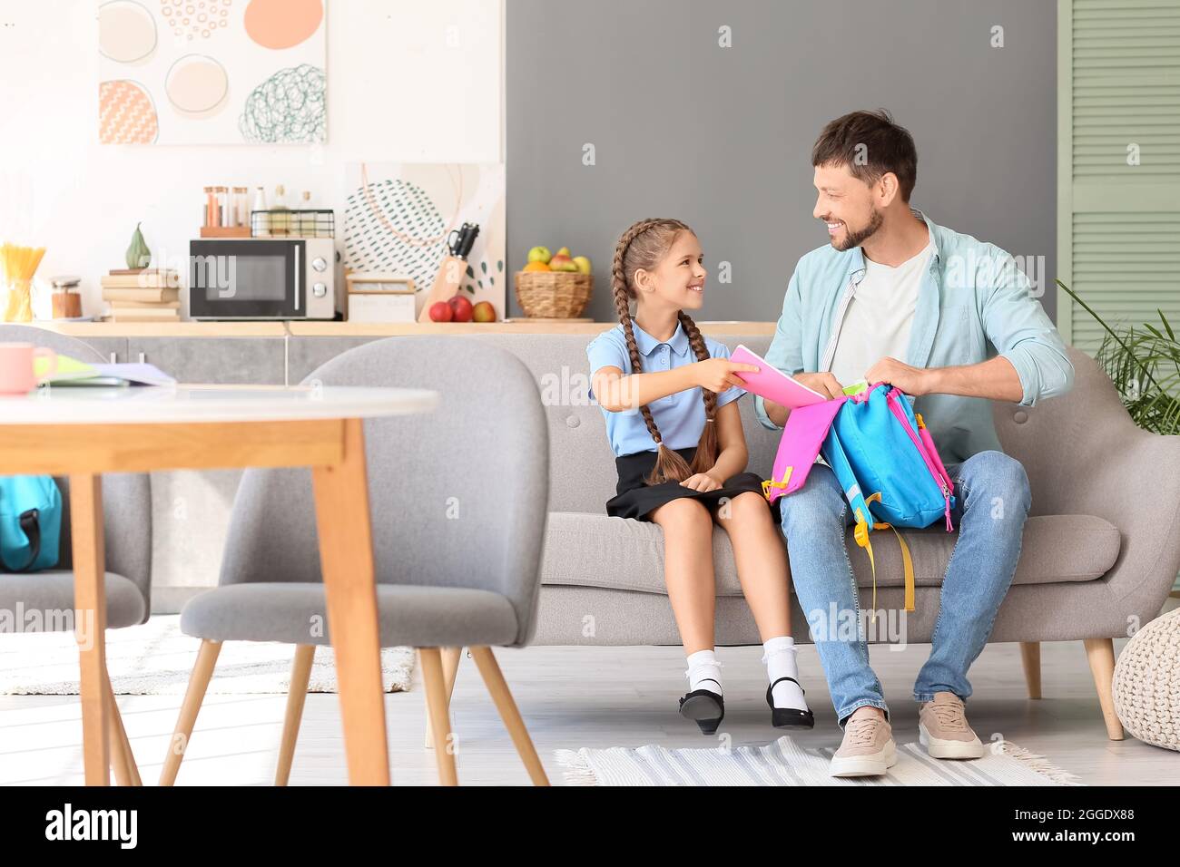 Father getting his little daughter ready for school Stock Photo - Alamy