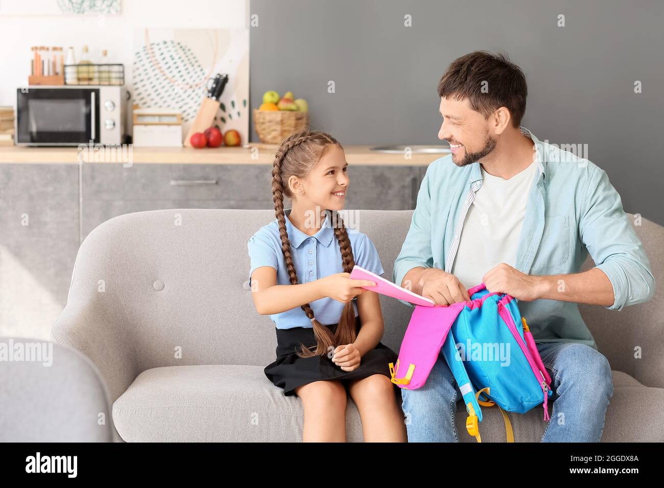 Father getting his little daughter ready for school Stock Photo - Alamy