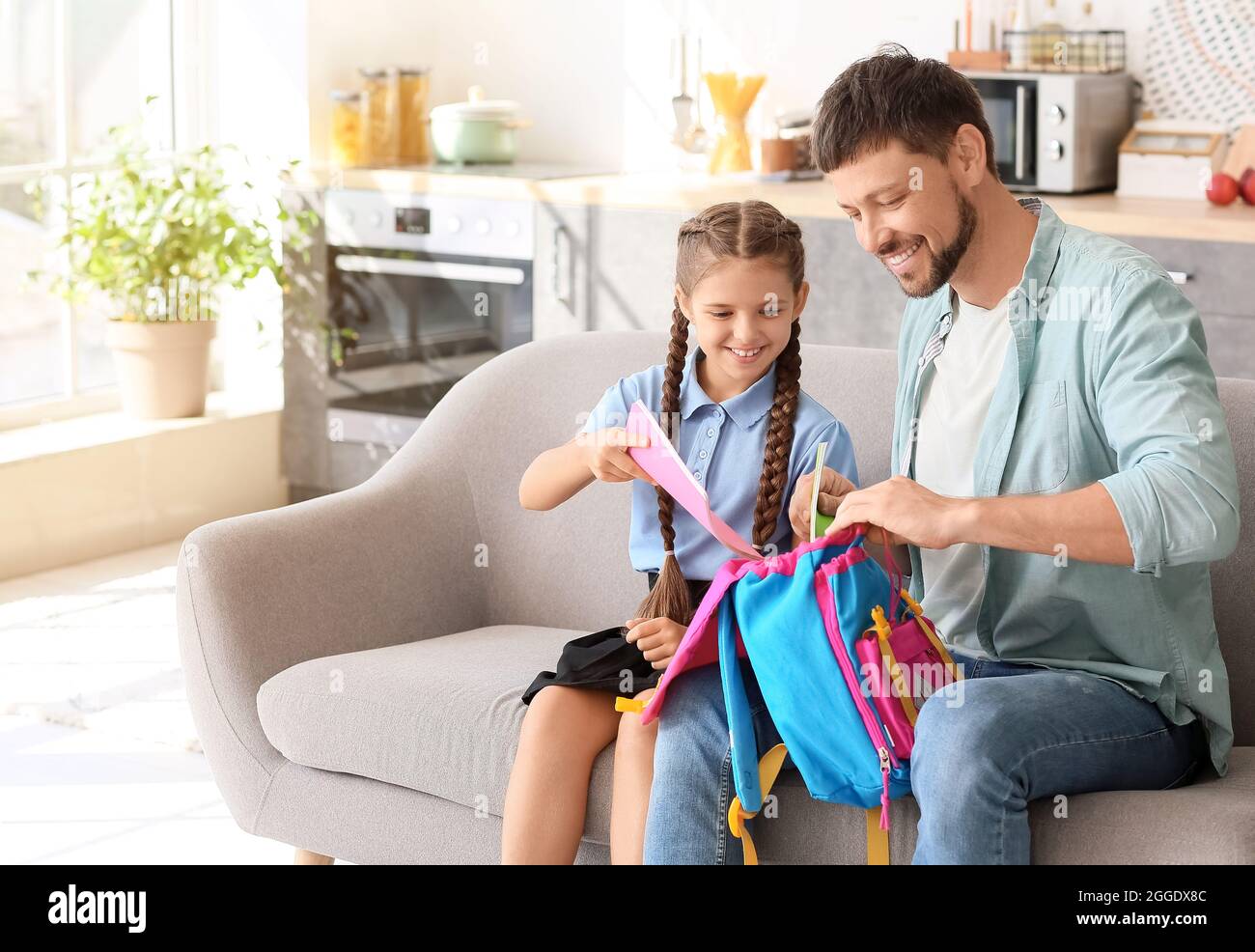 Father getting his little daughter ready for school Stock Photo - Alamy