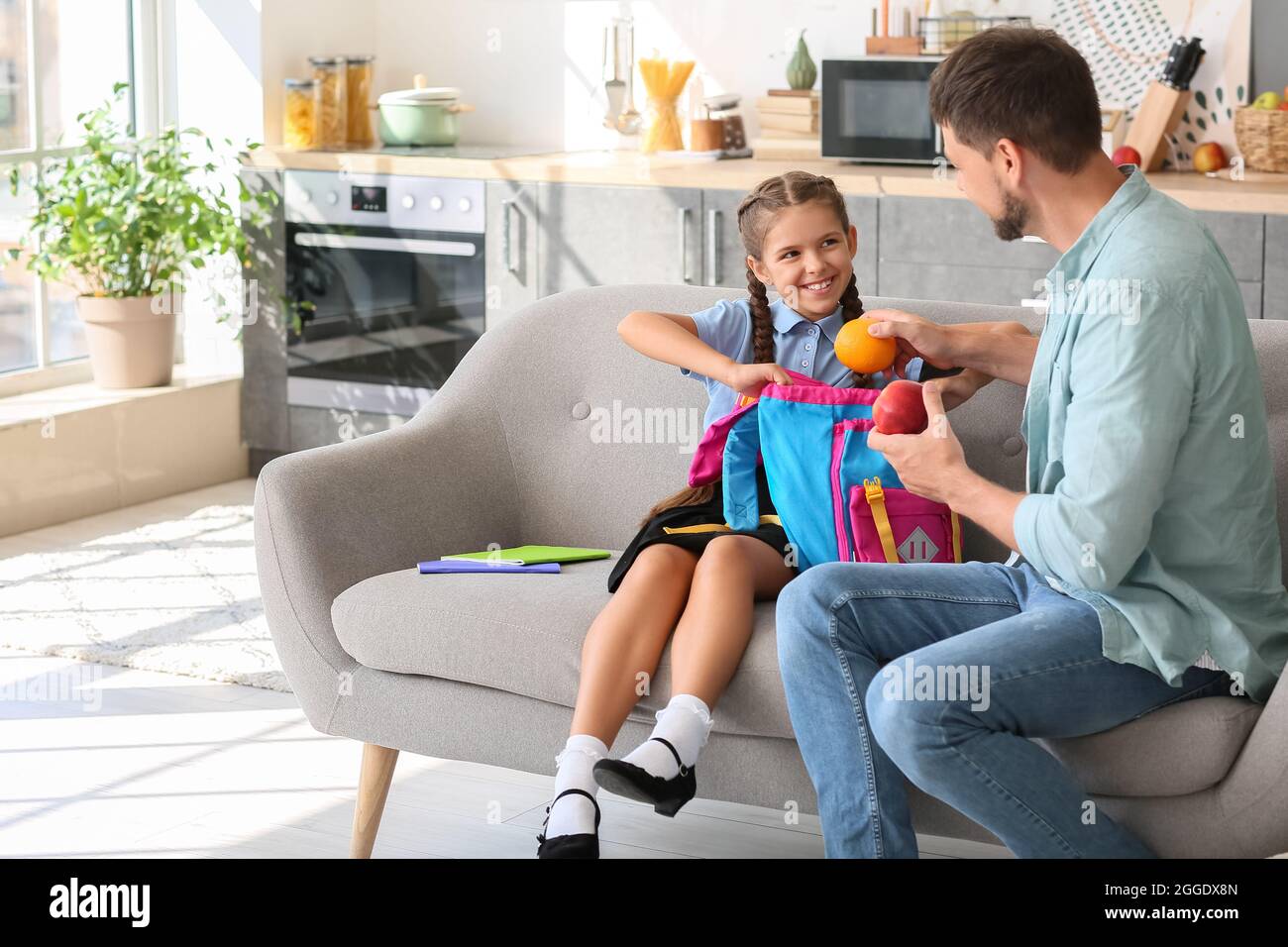 Father getting his little daughter ready for school Stock Photo - Alamy