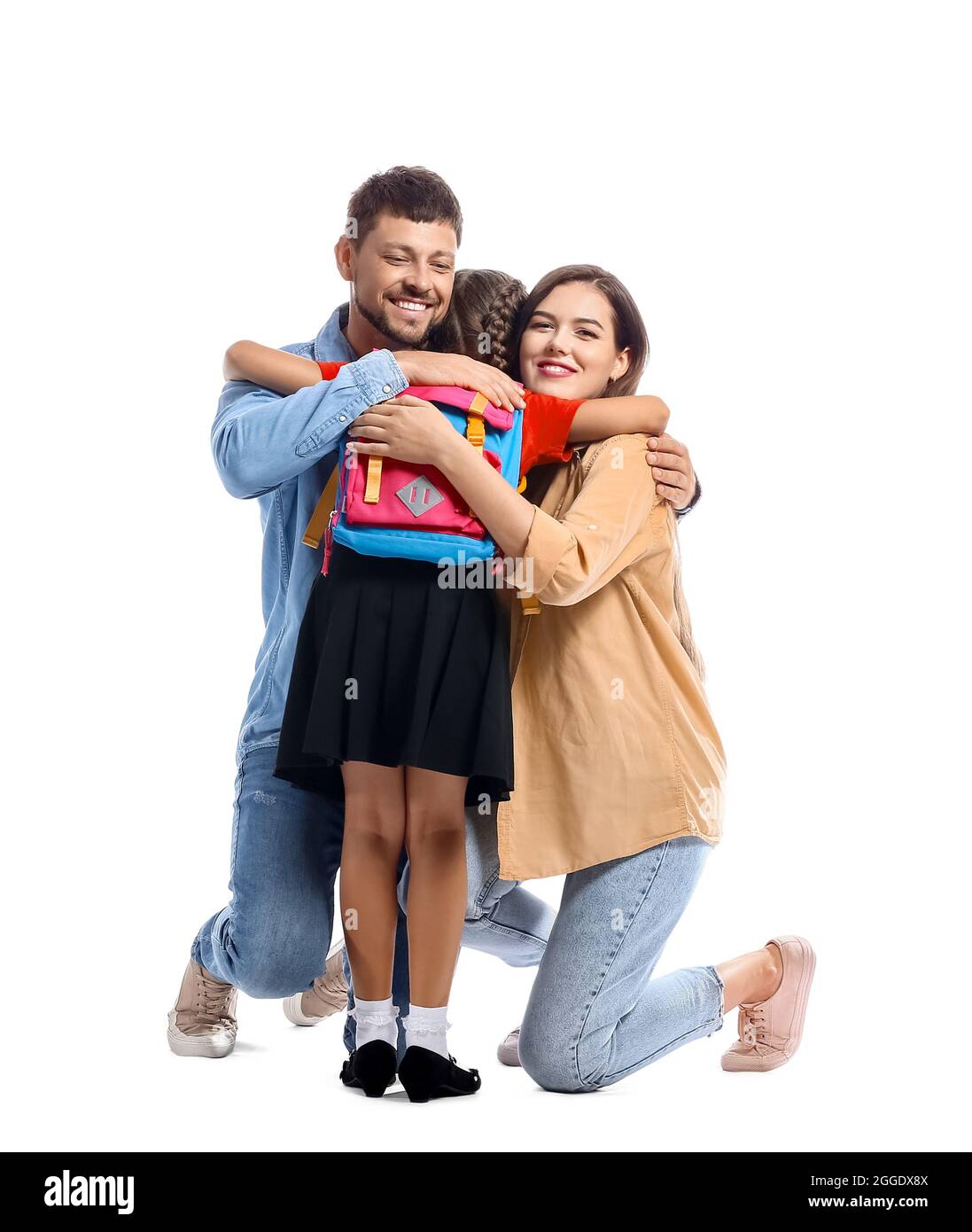 Little schoolgirl hugging her parents on white background Stock Photo ...