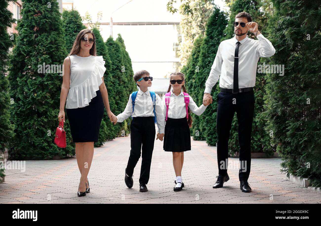 Cute little children going to school with their parents Stock Photo - Alamy