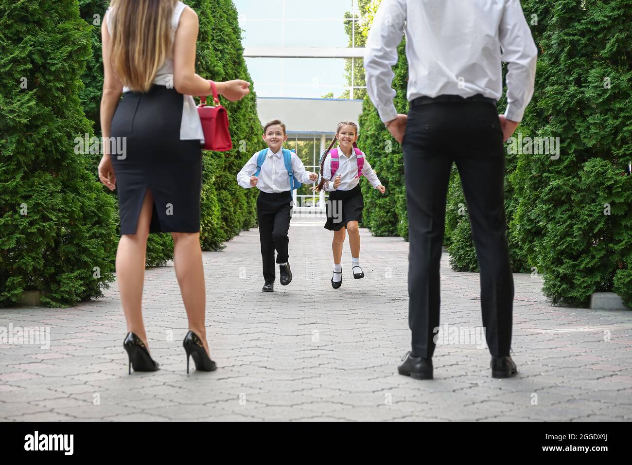 Parents meeting their little children after school Stock Photo - Alamy