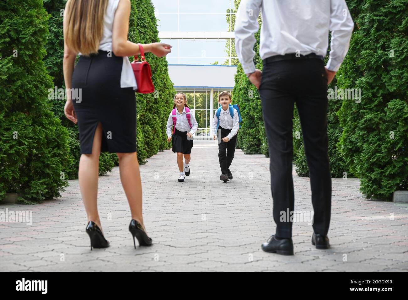 Parents meeting their little children after school Stock Photo - Alamy