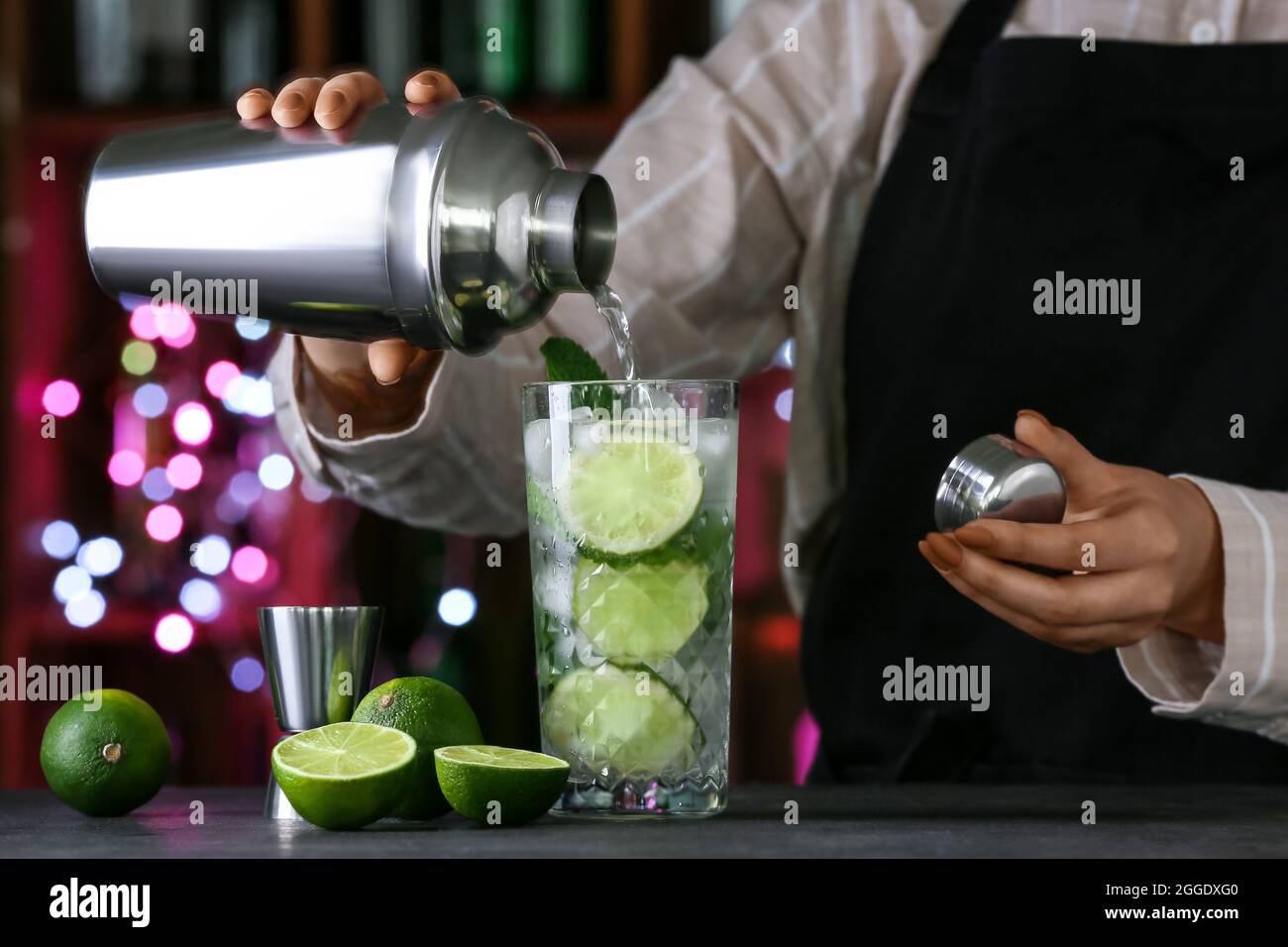 Female bartender making fresh mojito on table in bar Stock Photo - Alamy