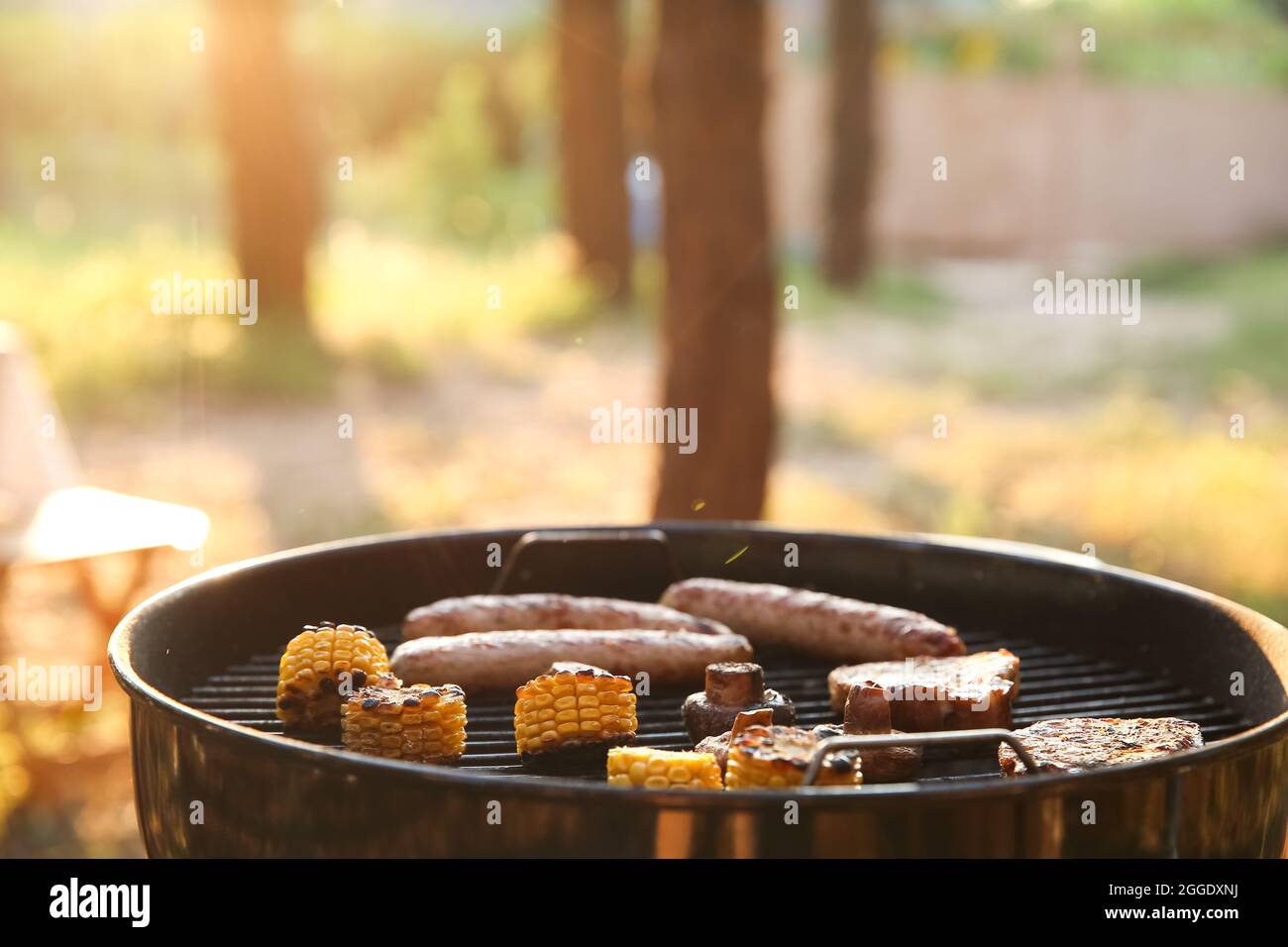 Modern barbecue grill with tasty food outdoors Stock Photo - Alamy
