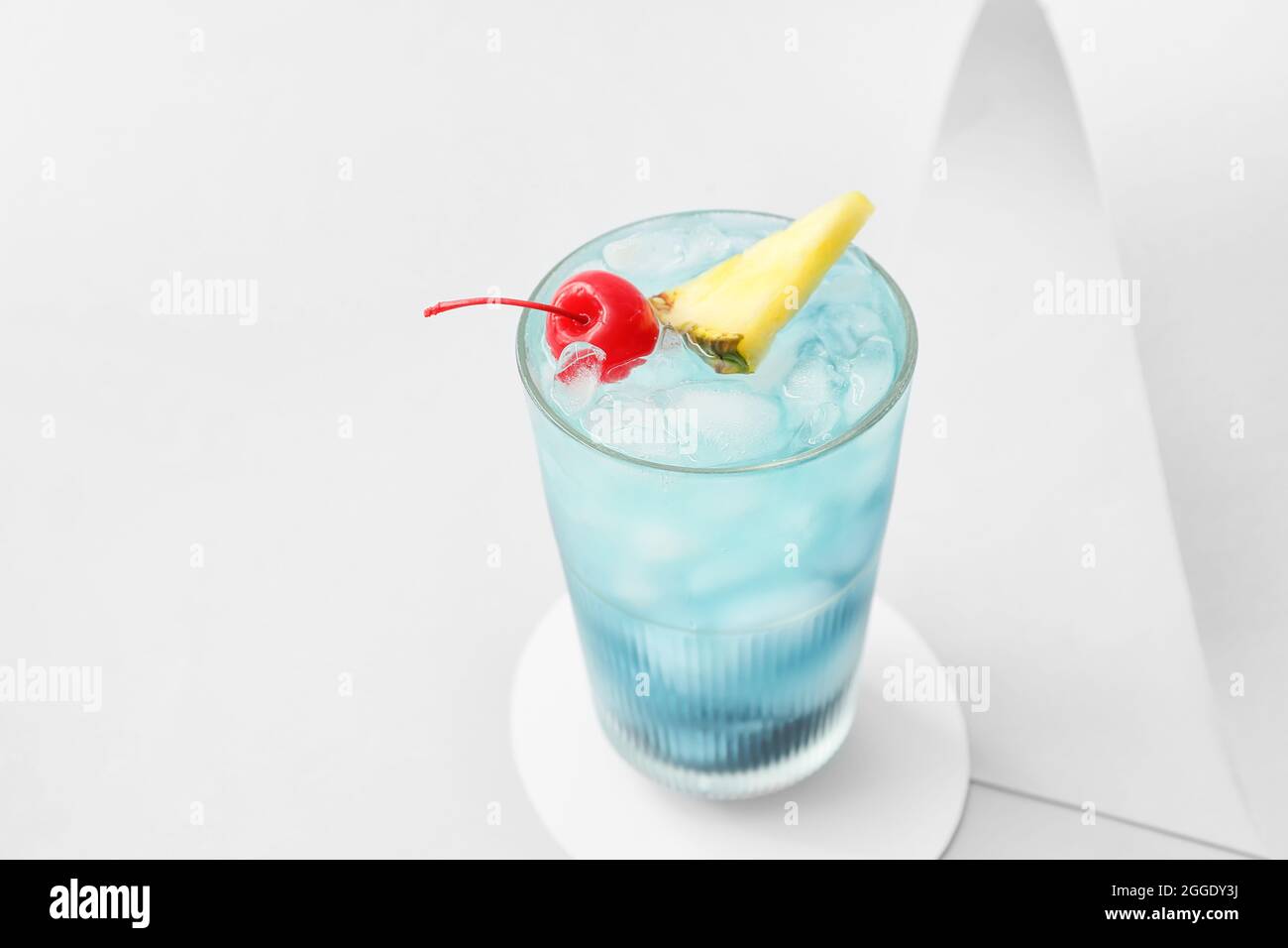 Glass of Blue Lagoon cocktail on light background Stock Photo - Alamy