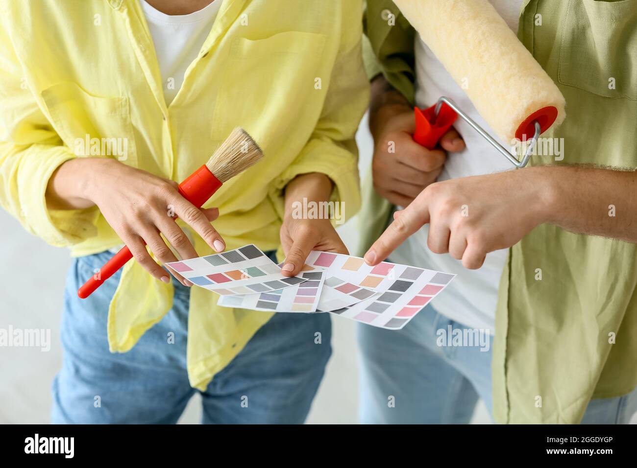 Young couple with palette samples planning design of their new house ...