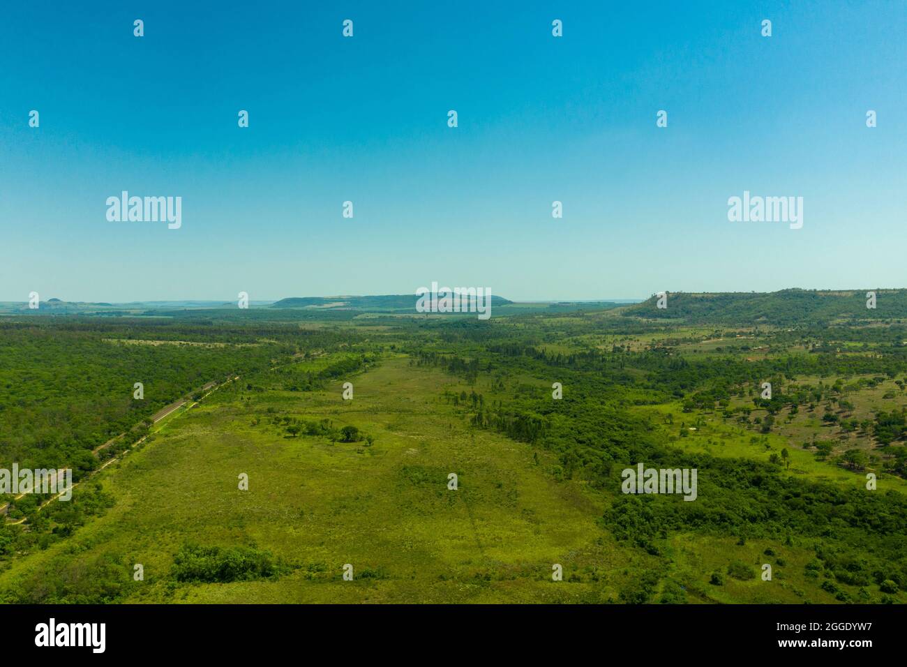aerial view of area with forest and mountains in the background on ...