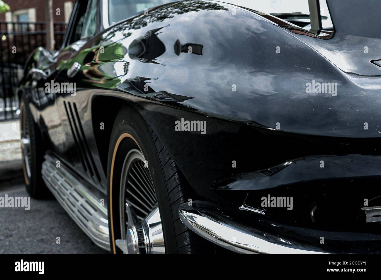 Rear view of a black luxury car parked on the sidewalk Stock Photo - Alamy