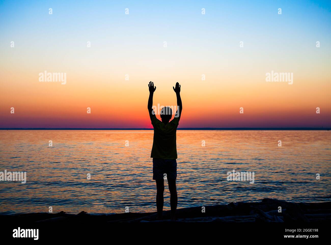 Happy Man Silhouette at the Sunset on the Sea Background Stock Photo ...