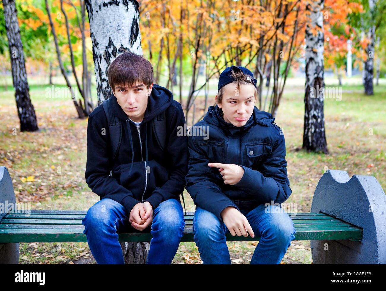 Two Sad Boys on the Bench in the Autumn Park Stock Photo - Alamy
