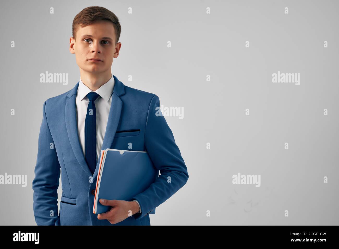 man in a suit with a blue folder in his hands work office official ...