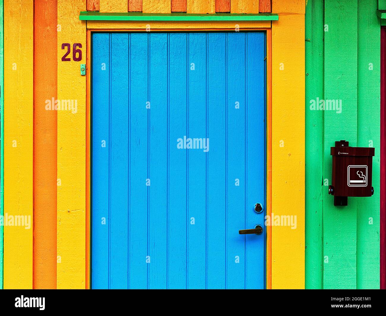 Traditional colourful wooden house, blue door, ashtray with pictogram ...