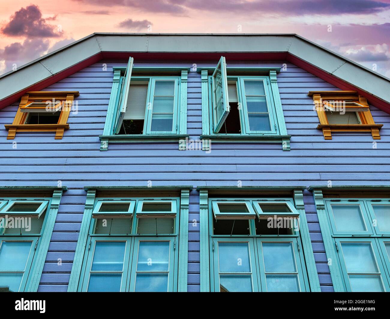 Traditional colourful wooden house in the evening, facade with open ...